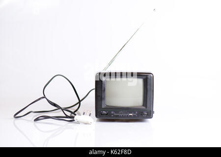 Vintage small portable color TV set with radio on white background ...
