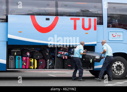Tui coach driver loading luggage at airport in Spain Stock Photo - Alamy