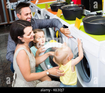 Home laundry. Smiling russian girl using washing machine at home Stock ...