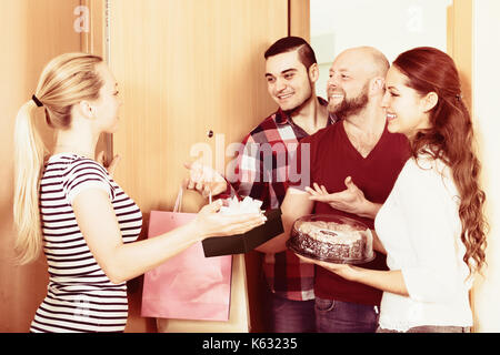 Family couple receiving visitors with the gifts at the home Stock Photo ...