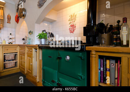 Green Aga oven in kitchen with multi-coloured wall tiles Stock Photo ...