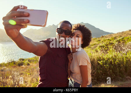 Young african couple pose for holiday selfie in city Stock Photo - Alamy