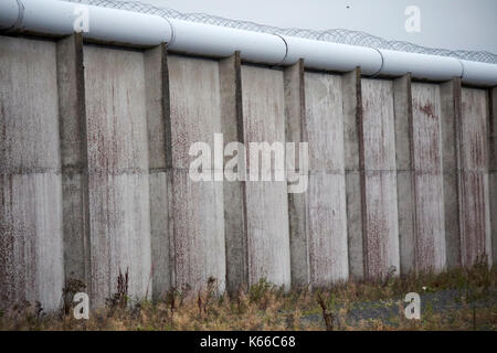 razor wire topped internal walls of one of the h blocks in the former ...