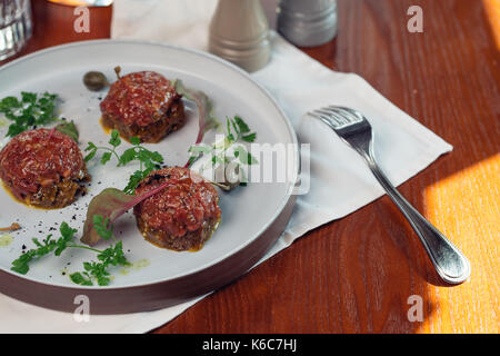 Delicious salmon tartar on dark wooden background, closeup Stock Photo ...