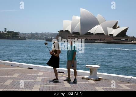 A woman take a selfie with a mobile phone at Wat Mangkon Kamalawat in ...