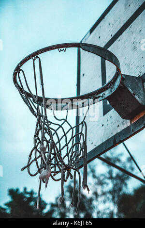 Urban Basketball hoop with worn out ripped net Stock Photo - Alamy
