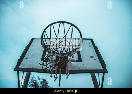 Urban Basketball hoop with worn out ripped net Stock Photo - Alamy