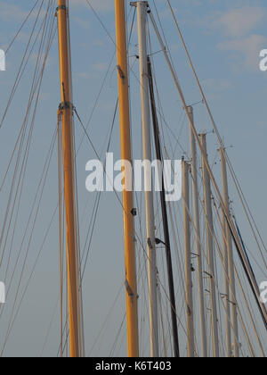 A wooden sailing ship with multiple masts and sails, carrying ...