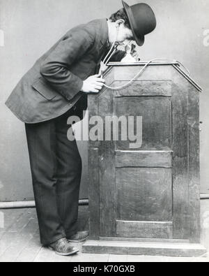 Thomas Alva Edison with his motion picture apparatus 1893. Hand-colored ...
