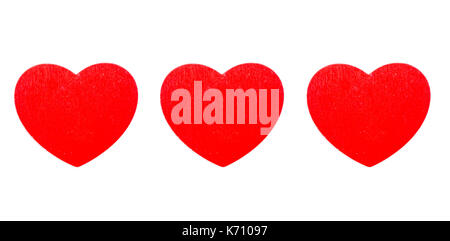 Three red hearts in a row cut from paper on white background, craft ...