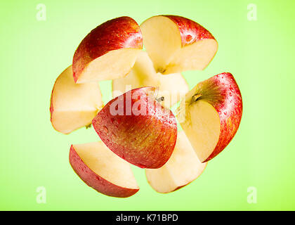 floating green apple cut in half by knife on white background Stock ...