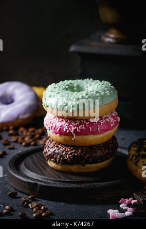 Colorful sweet donuts with black coffee Stock Photo - Alamy