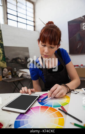 Beautiful woman matching color with color swatch at table Stock Photo ...