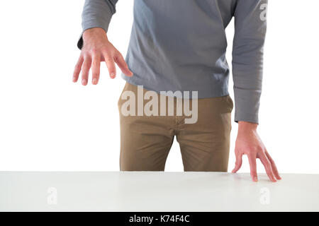 Mid section of businessman gesturing at table Stock Photo - Alamy