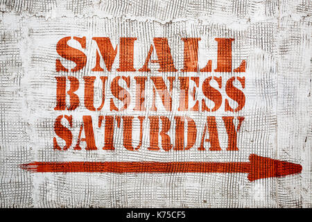 Small business Saturday - graffiti sign with arrow on stucco wall Stock ...