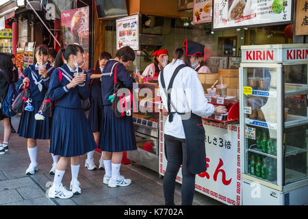 Japanese school girls sampling street food in Chinatown, Yokohama ...
