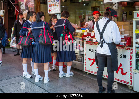 Japanese school girls sampling street food in Chinatown, Yokohama ...