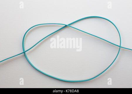 Heart-shaped tie of electric wire on white canvas background Stock ...