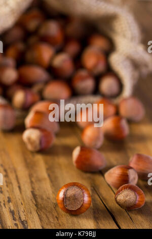 Hazelnuts on burlap background Stock Photo - Alamy