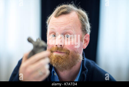 Sven Sachs, a paleo-herpetologist, studying bone fragments of an ...