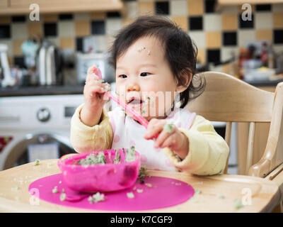 baby eating messy mashed potato Stock Photo - Alamy
