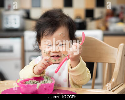 baby eating messy mashed potato Stock Photo - Alamy