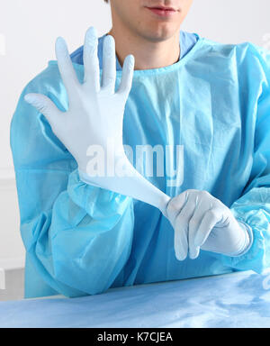 doctor in blue uniform and latex gloves is holding an empty plastic ...