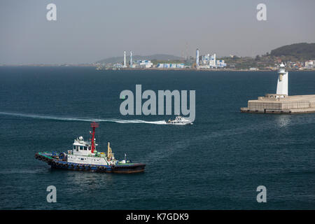 A tugboat in the harbor at the port of Jeju, Jeju Island, South Korea ...