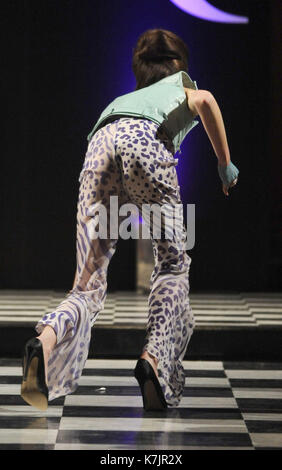 A model on the catwalk falls over during the Mila Schon fashion show ...