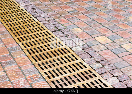 The sewer grate on the sidewalk is rusty close up Stock Photo - Alamy