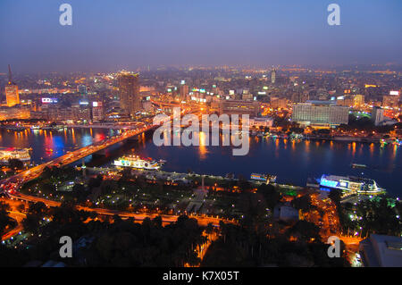 Aerial view of the city of Cairo at night along the river Nile. Skyline ...