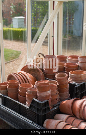 A collection of clay pots in various shapes, sizes, and colors are ...