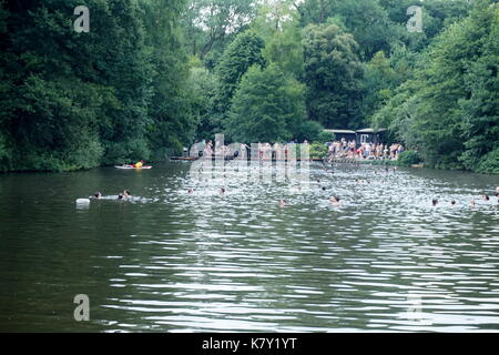 Swimmers in the Hampstead Heath mixed bathing pond in London as it ...