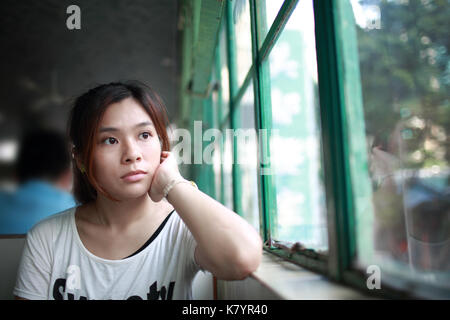 Sad woman waiting someone who is late, after cry,she look outside ...