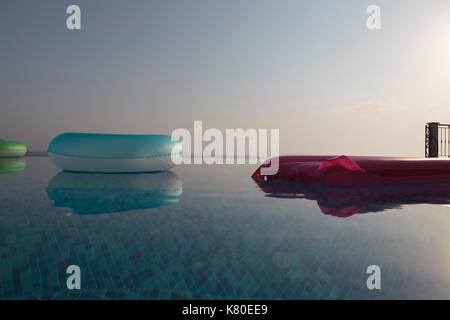 Lie Low and floating rings in swimming pool Stock Photo - Alamy