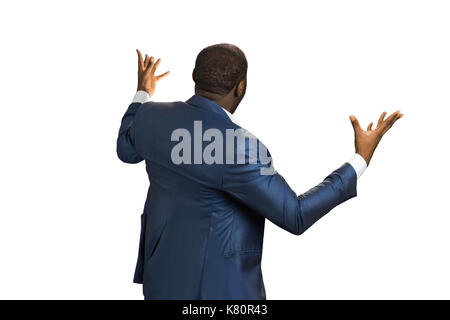 Back view of shocked and scared young man. Hold hands upwards. Rear ...