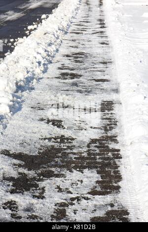 Snow and ice walkway on a winter day Stock Photo - Alamy