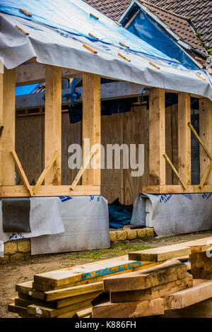 A house extension undergoing construction, with a substantial wooden ...