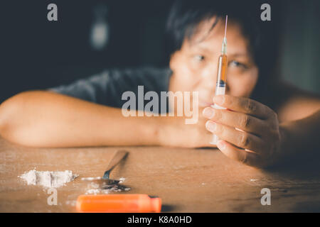 Bad woman. Addict lady with syringe using drugs Stock Photo - Alamy