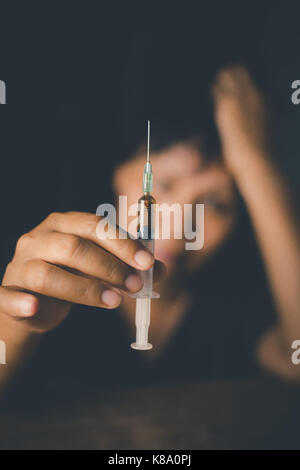Bad woman. Addict lady with syringe using drugs Stock Photo - Alamy
