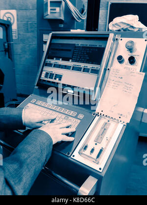Display of programmable machine with big red button. Milling and lathe ...