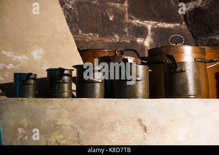 Old set of old pans in medieval kitchen Stock Photo - Alamy