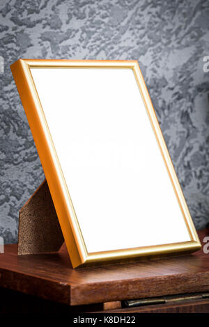 Blank wooden photo frame stands in the interior on a white background ...