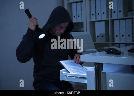 A burglar searching a drawer Stock Photo - Alamy