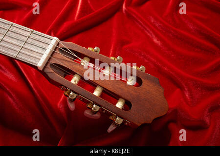 acoustic guitar on red velvet fabric, closeup object Stock Photo - Alamy