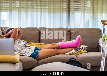 Lady with a broken ankle with her leg in an elevated position Stock ...