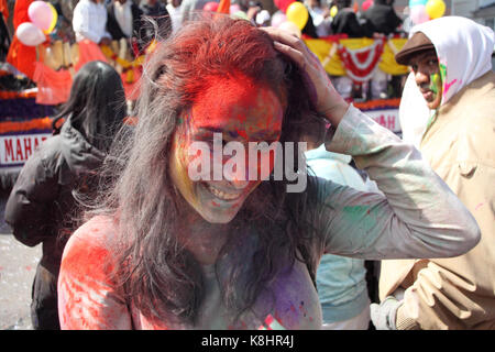 Powder-covered revelers attend the Phagwah Parade celebrating Holi in ...