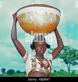 Fulani Milk Maid. Calabash, with hand incised decoration, balanced on ...