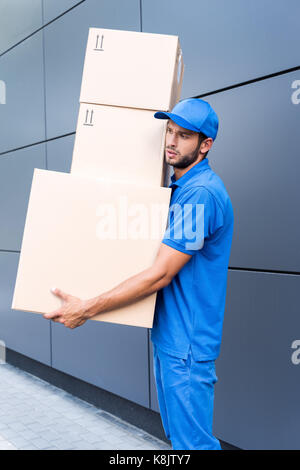 Workman carrying boxes Stock Photo - Alamy