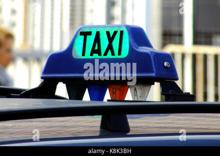Taxi sign on the road, detail of a text signal in soil, urban transport ...